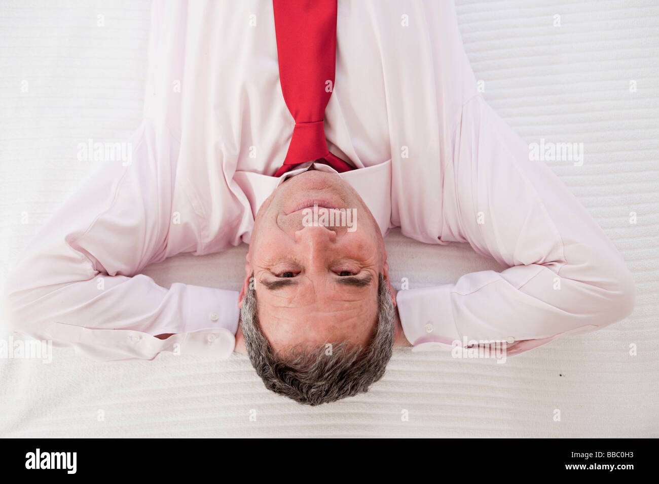 man lying on bed looking at viewer Stock Photo - Alamy