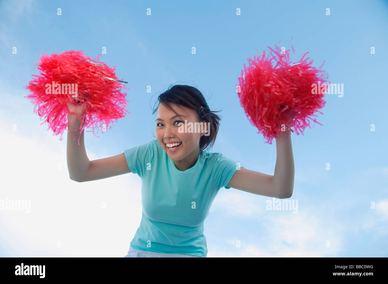 Young woman cheerleading pom poms hi-res stock photography and images ...