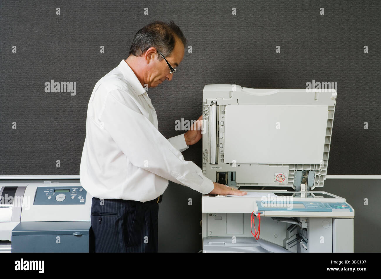 Man making photocopy in office Stock Photo - Alamy