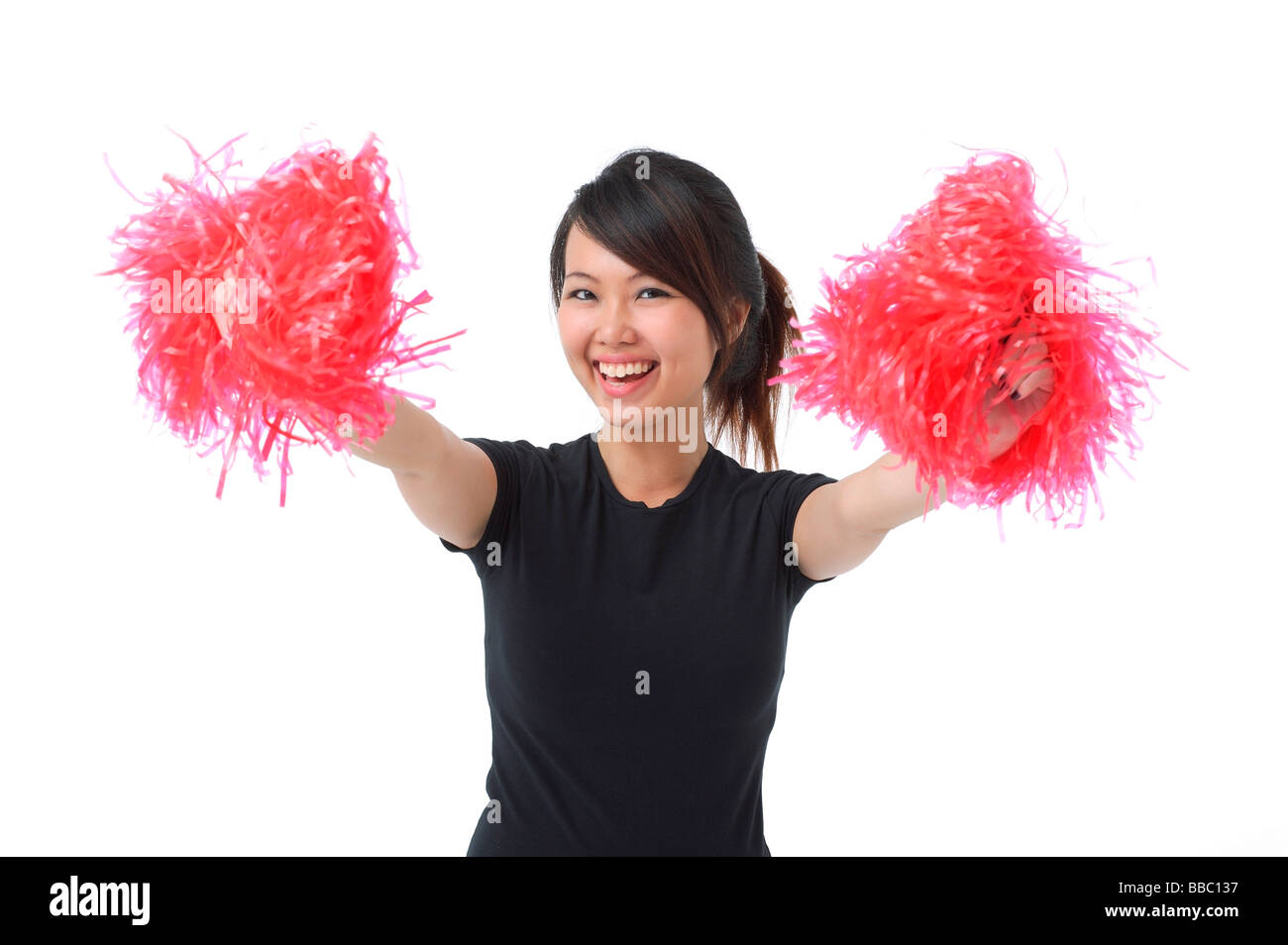 Young woman cheerleading with pom poms Stock Photo - Alamy