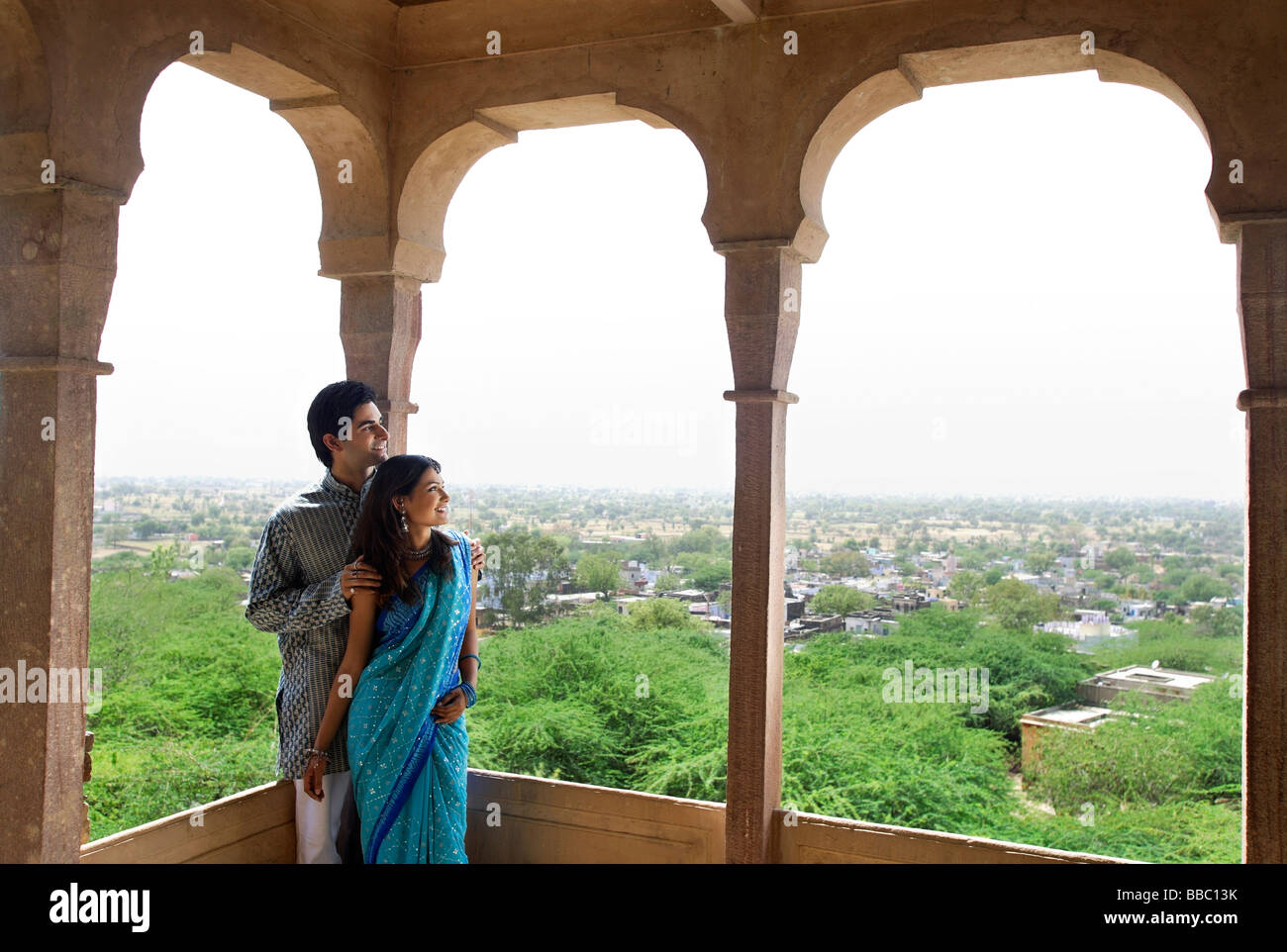 young couple looking out from terrace balcony Stock Photo - Alamy