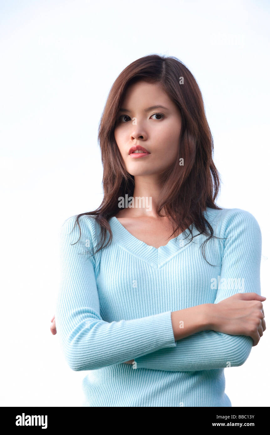 Woman with arms crossed, looking at camera Stock Photo - Alamy