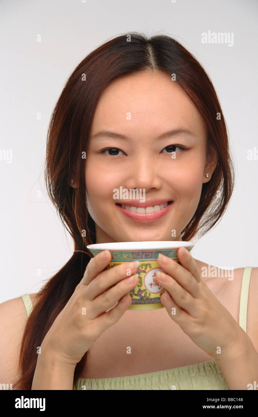 Young woman with traditional tea cup smiling at camera Stock Photo - Alamy