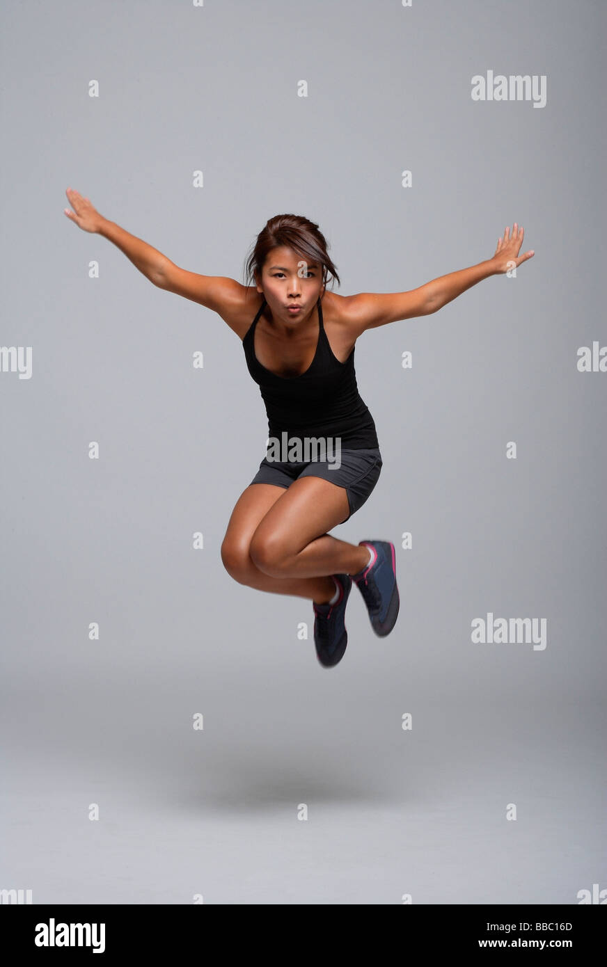 Young woman jumping up Stock Photo - Alamy