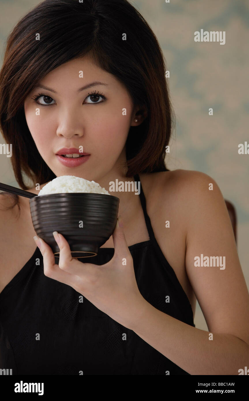 Young woman with bowl of rice Stock Photo - Alamy