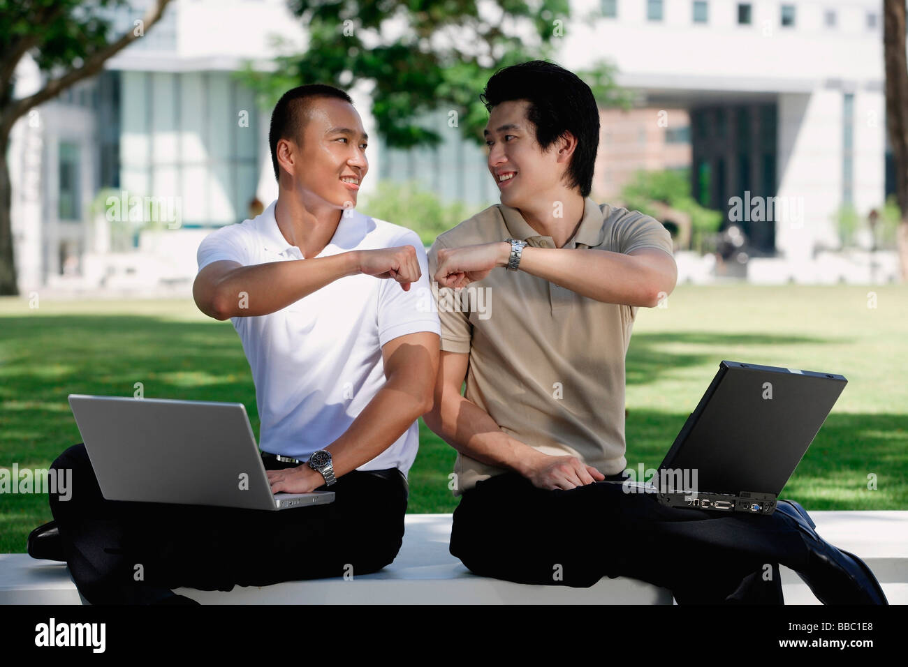 Two men use their laptops in the park Stock Photo - Alamy