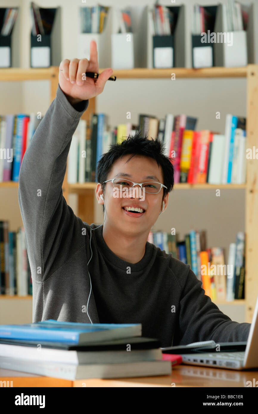 A young man studies in the library Stock Photo - Alamy