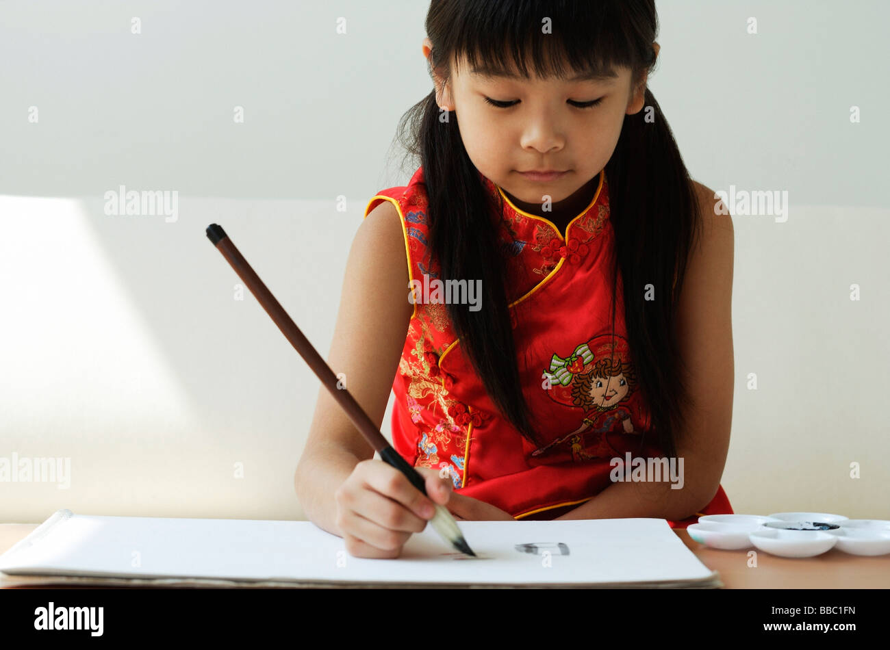 Young girl practicing calligraphy Stock Photo - Alamy