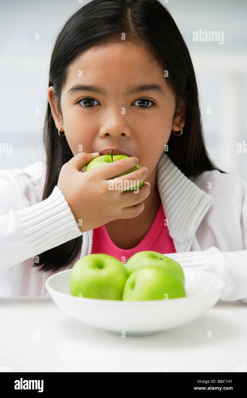 Girl eating green apple Stock Photo - Alamy