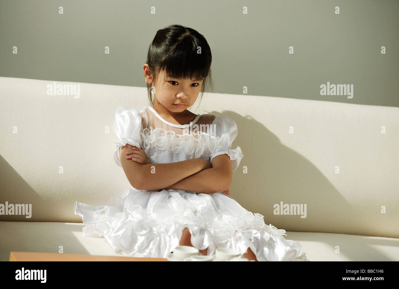 Girl in white dress pouting Stock Photo - Alamy