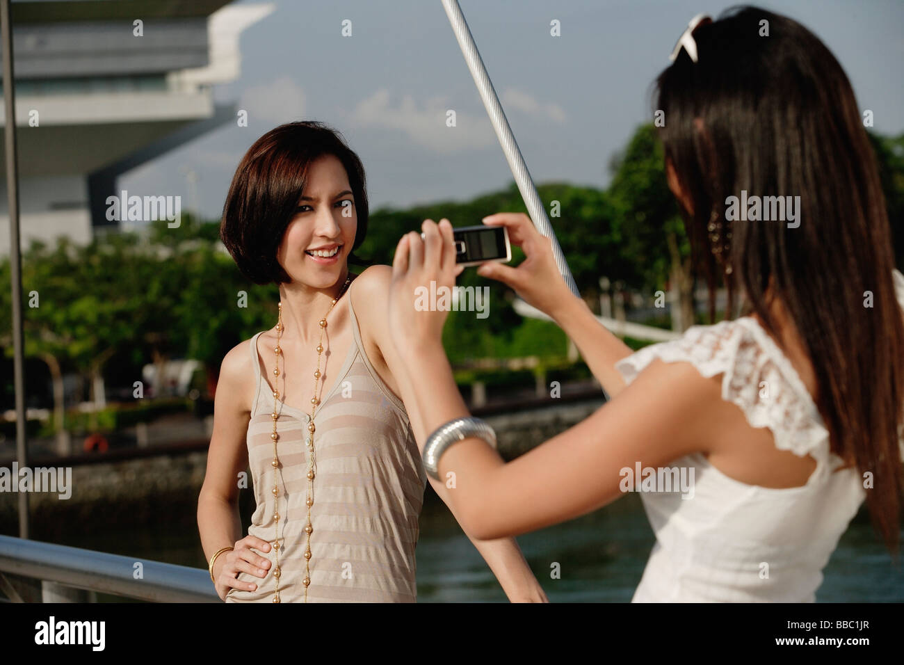 Friends take photos of each other on a bridge Stock Photo - Alamy