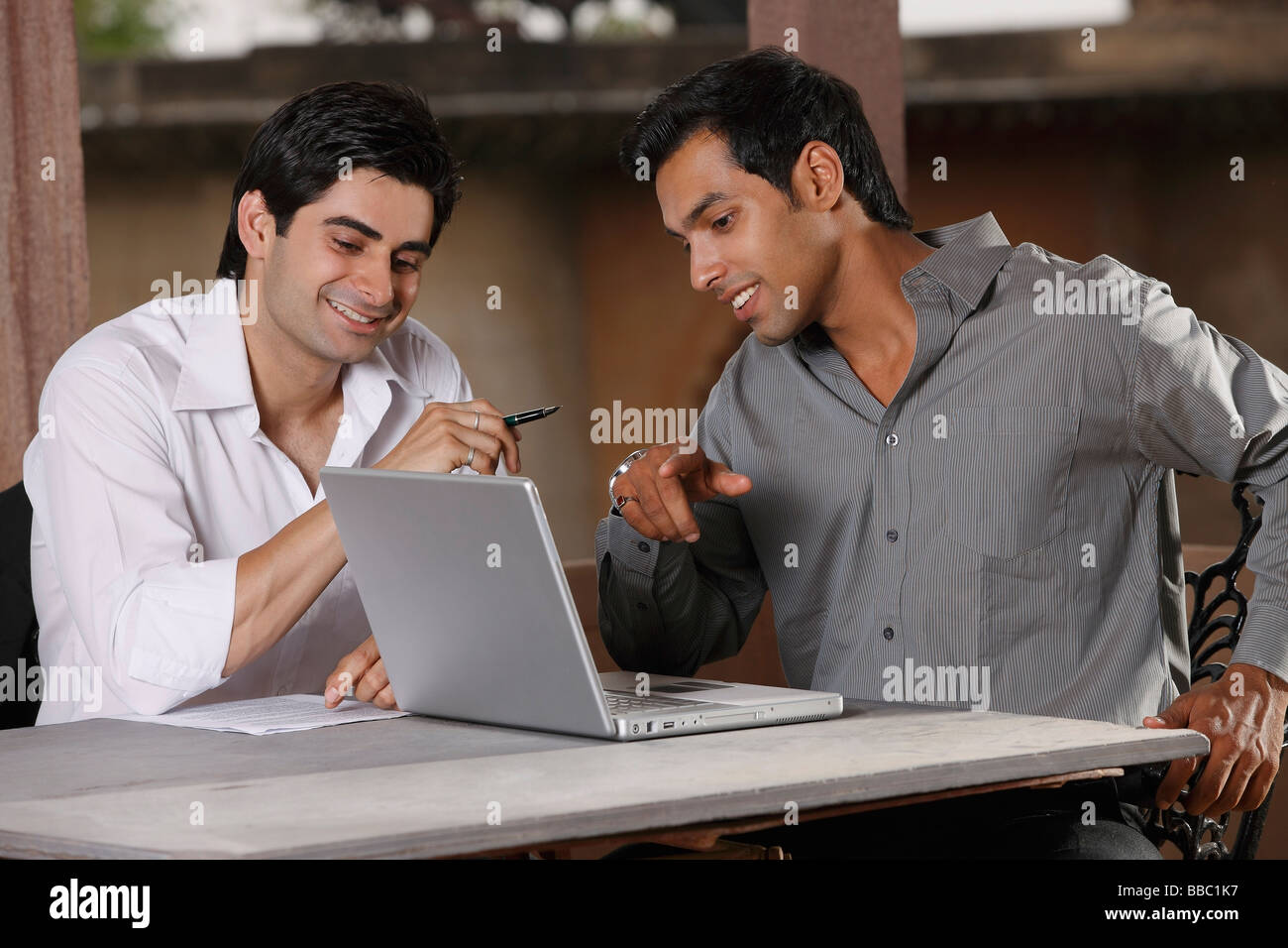men working at laptop computer Stock Photo - Alamy