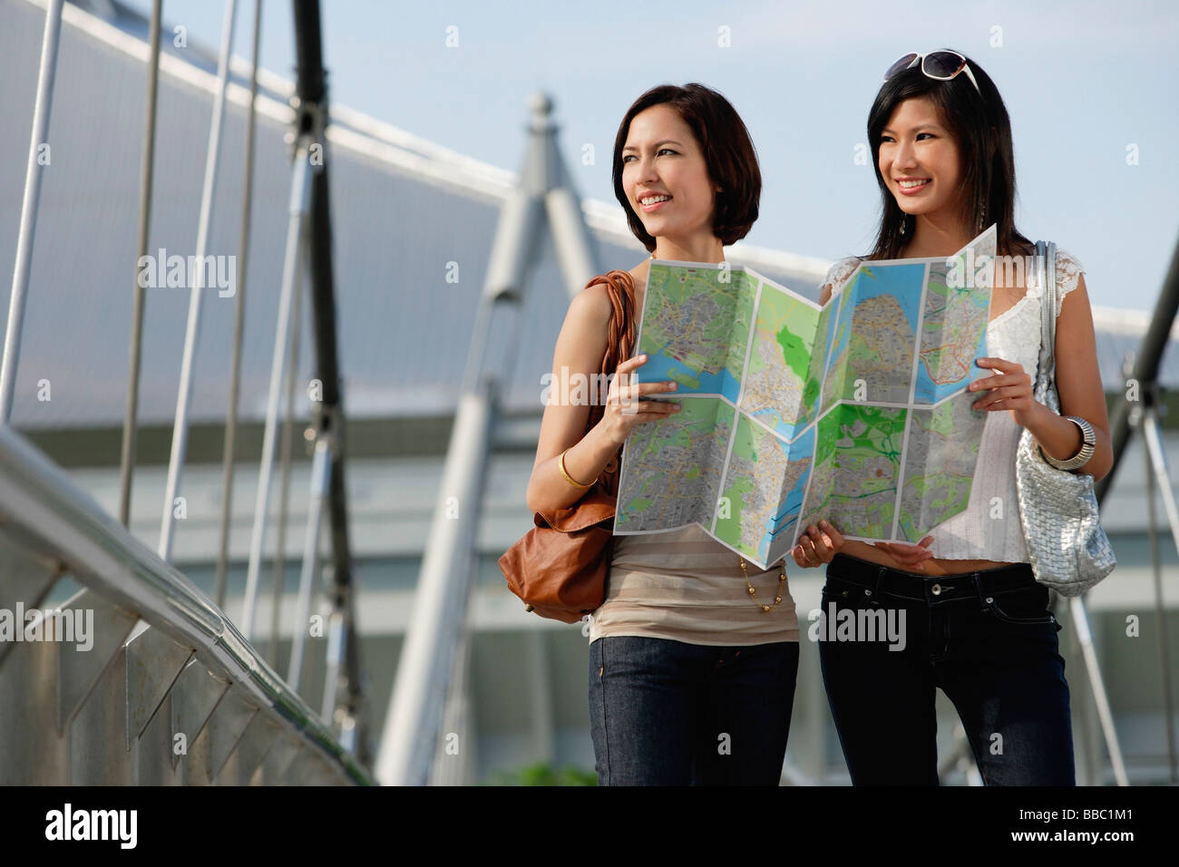 Two friends check a map together Stock Photo - Alamy
