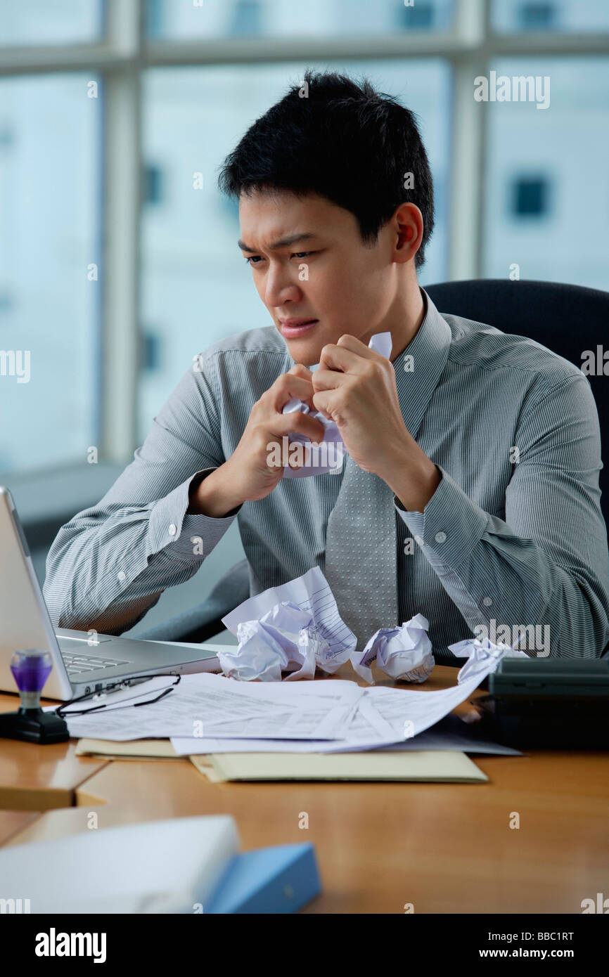 Stressed young man laptop messy desk hi-res stock photography and ...