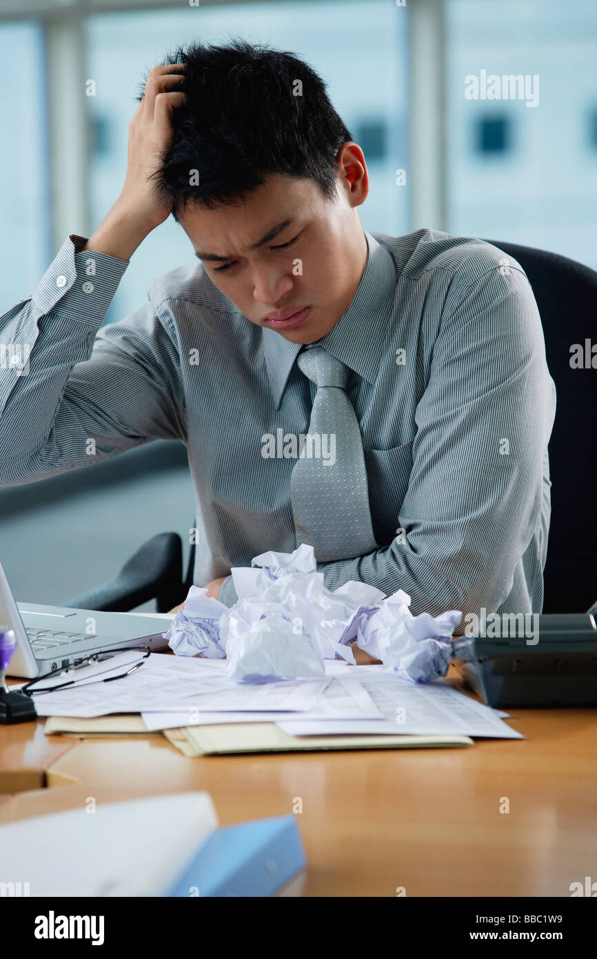 A man looks stressed as he works at his desk Stock Photo - Alamy