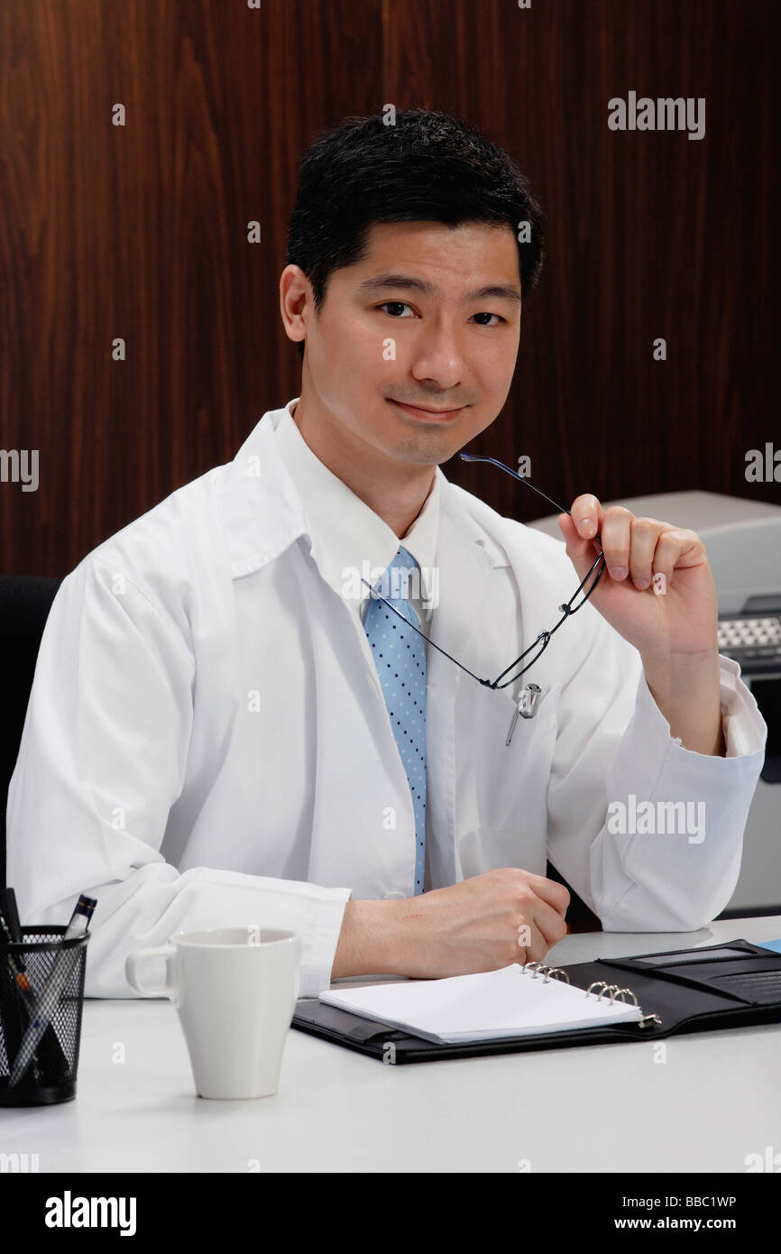 A doctor sits at his desk Stock Photo - Alamy