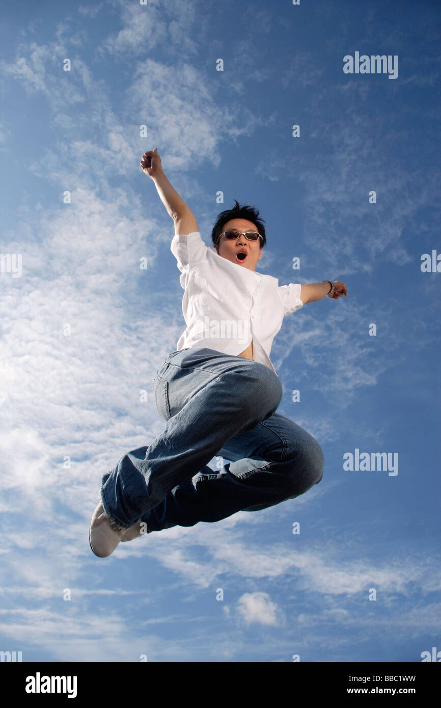 A young man jumps for joy Stock Photo - Alamy