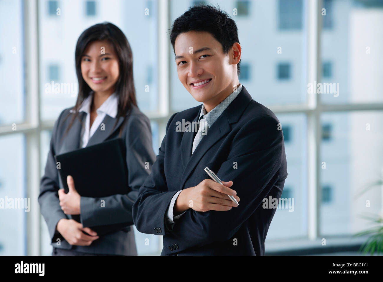 Work colleagues smile at the camera together Stock Photo - Alamy