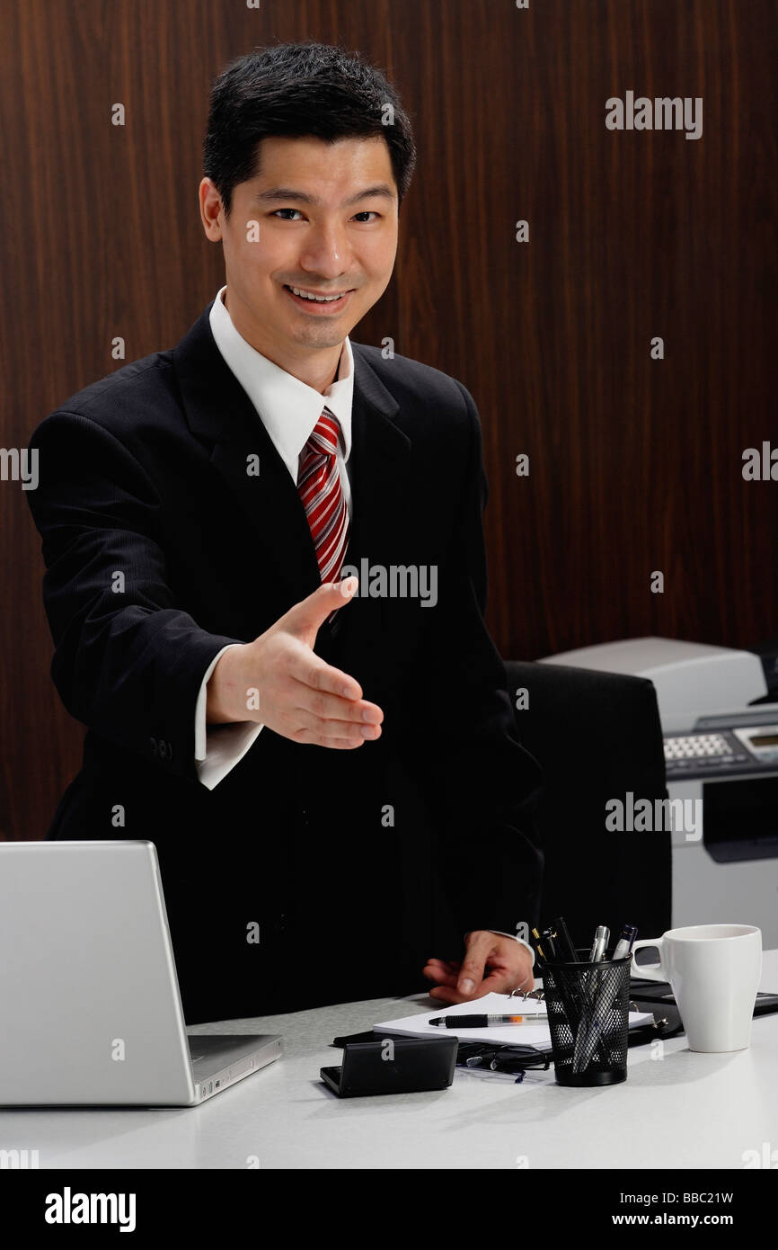 A businessman extends his hand to shake hands Stock Photo - Alamy