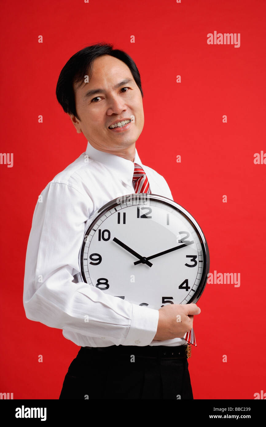 Holds a clock hi-res stock photography and images - Alamy