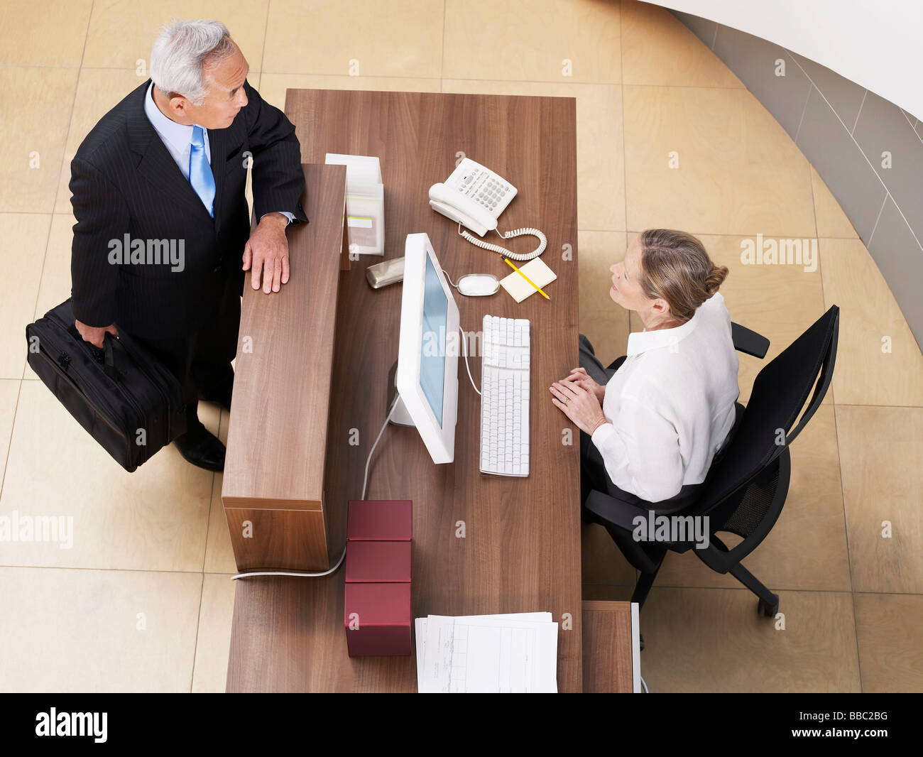Businessman woman sitting reception desk hi-res stock photography and ...