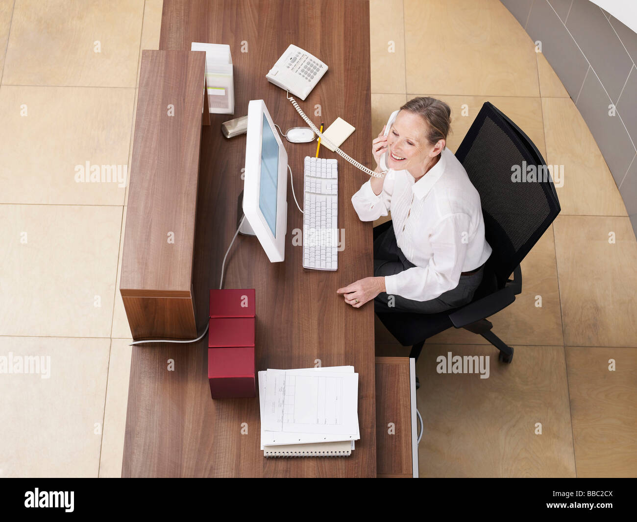 Office receptionist seen from above Stock Photo - Alamy