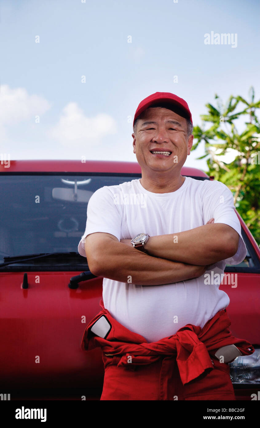 A man with a red van smiles at the camera as he works Stock Photo - Alamy