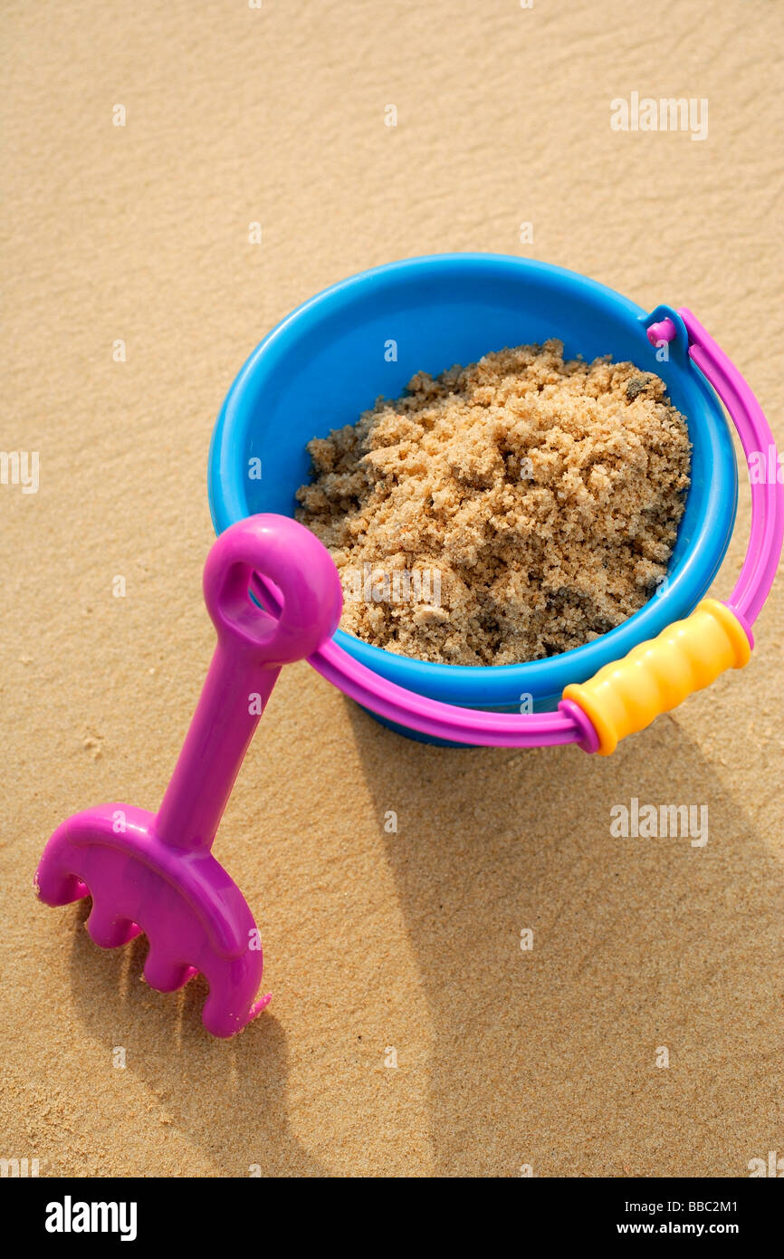 Beach Bucket filled with sand and shovel leaning against bucket Stock ...