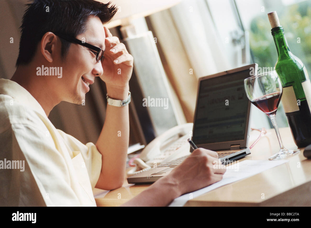 Man writing, smiling Stock Photo - Alamy