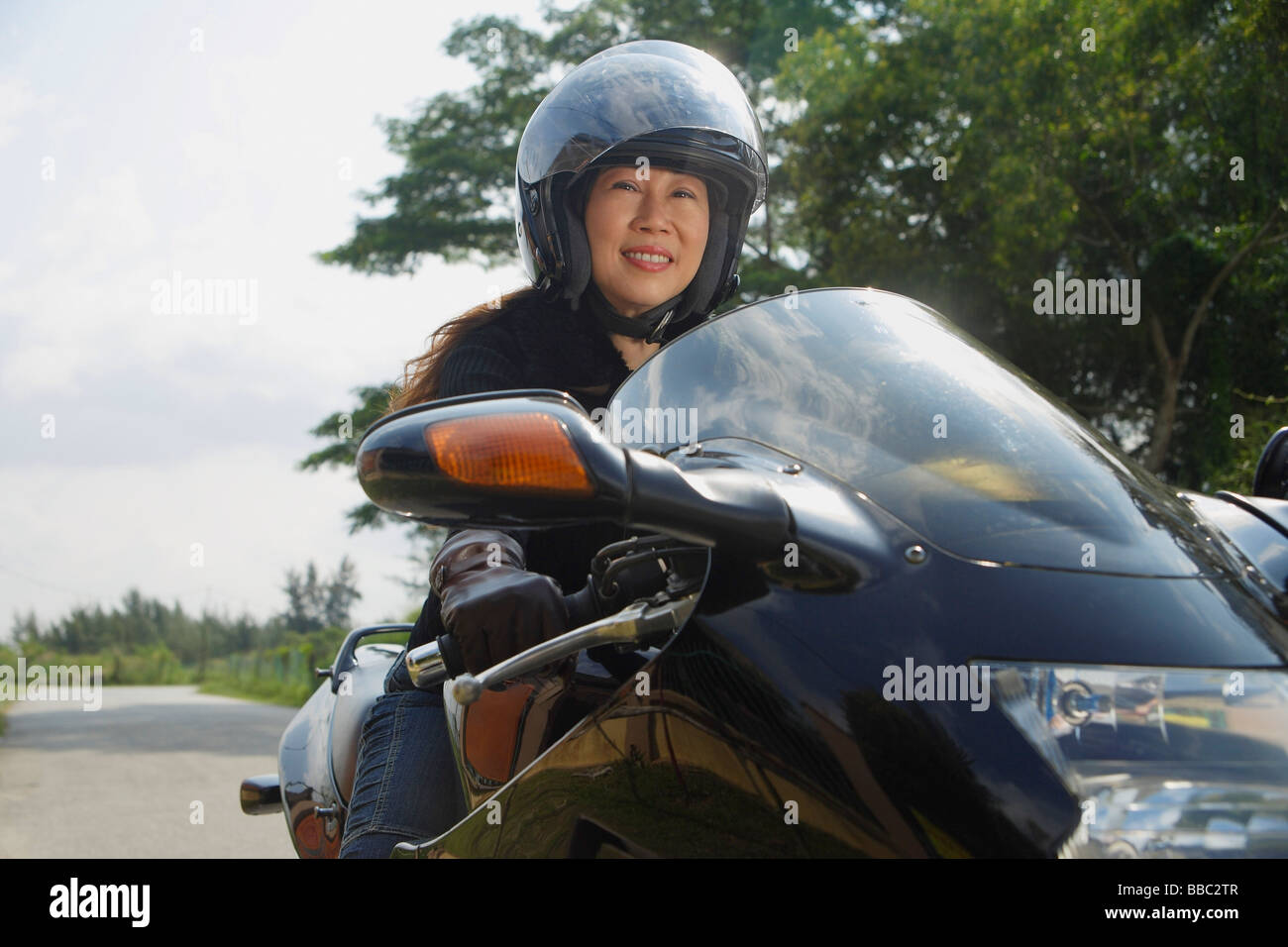 Mature woman riding motorcycle hi-res stock photography and images - Alamy