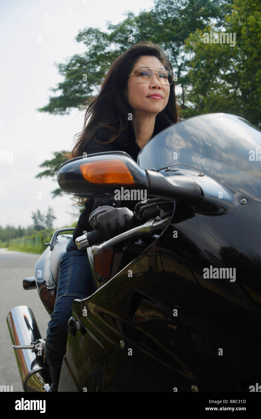Mature woman riding motorcycle hi-res stock photography and images - Alamy