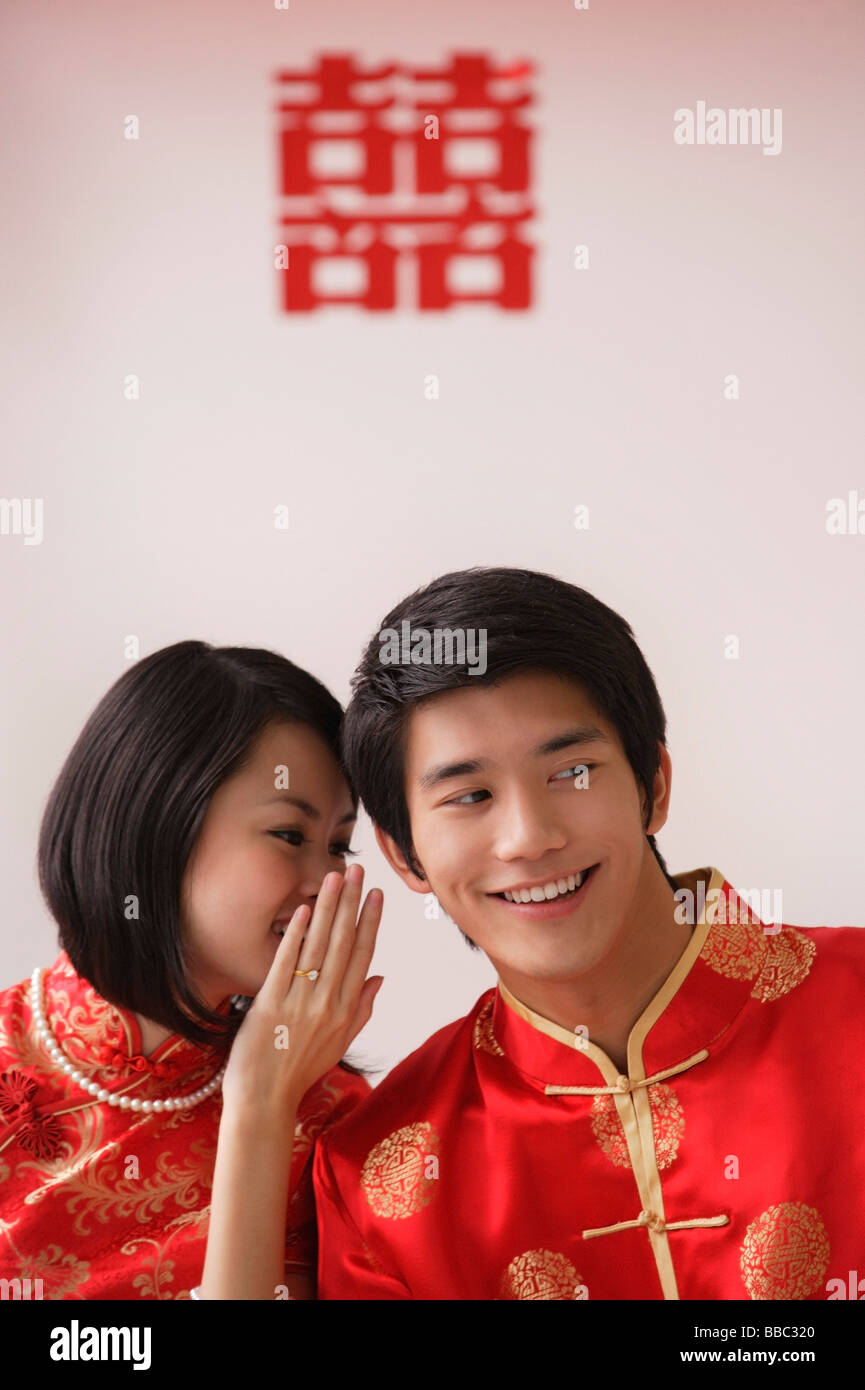 A newlywed couple whisper to each other Stock Photo - Alamy