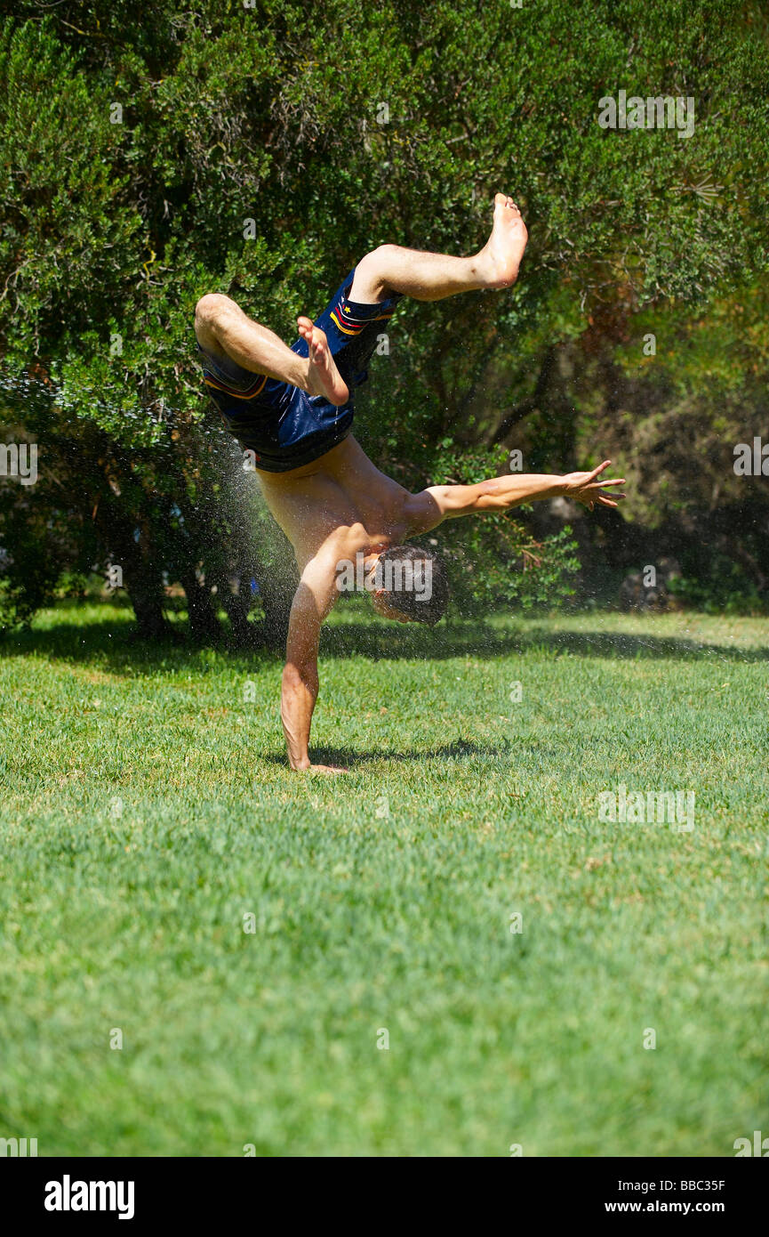 Young man doing hand stands Stock Photo - Alamy