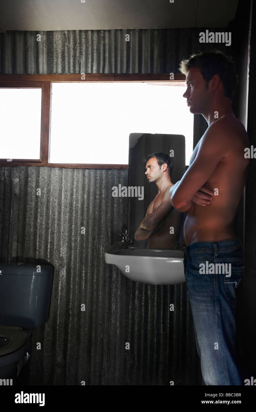 Man standing in bathroom Stock Photo - Alamy