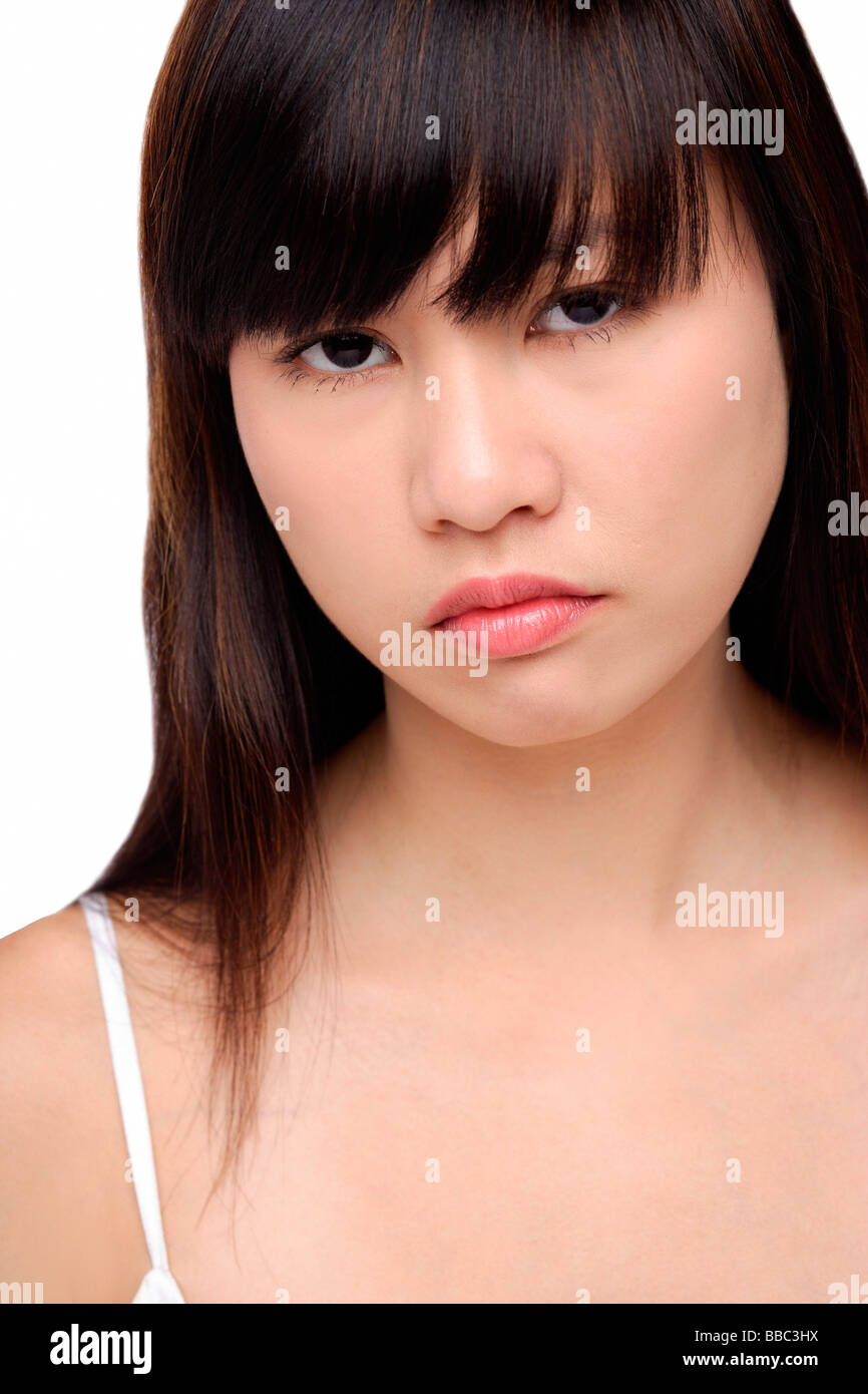 Young woman frowning, portrait Stock Photo - Alamy