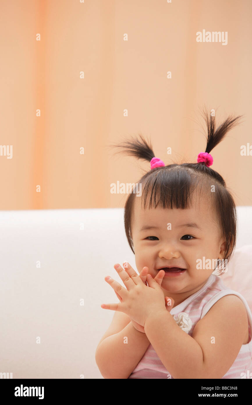 Baby Girl clapping hands and laughing, looking at camera Stock Photo ...