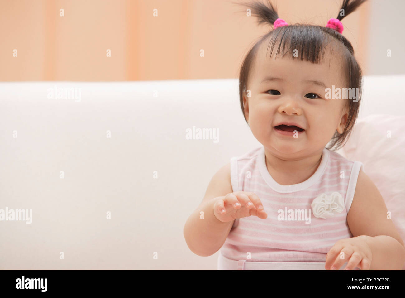 Baby girl laughing and smiling at camera Stock Photo - Alamy