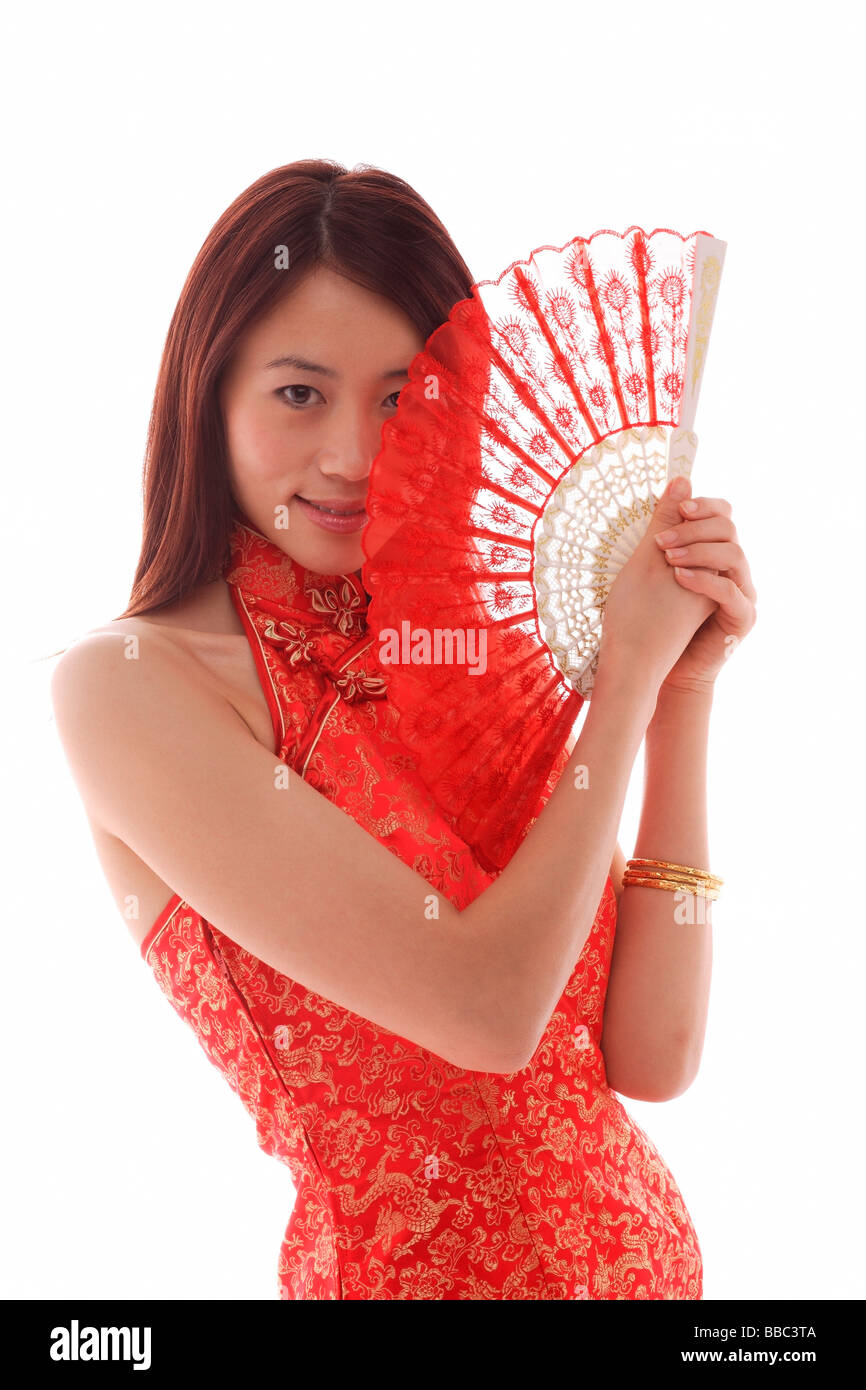 Young woman wearing cheongsam and holding Chinese fan Stock Photo - Alamy