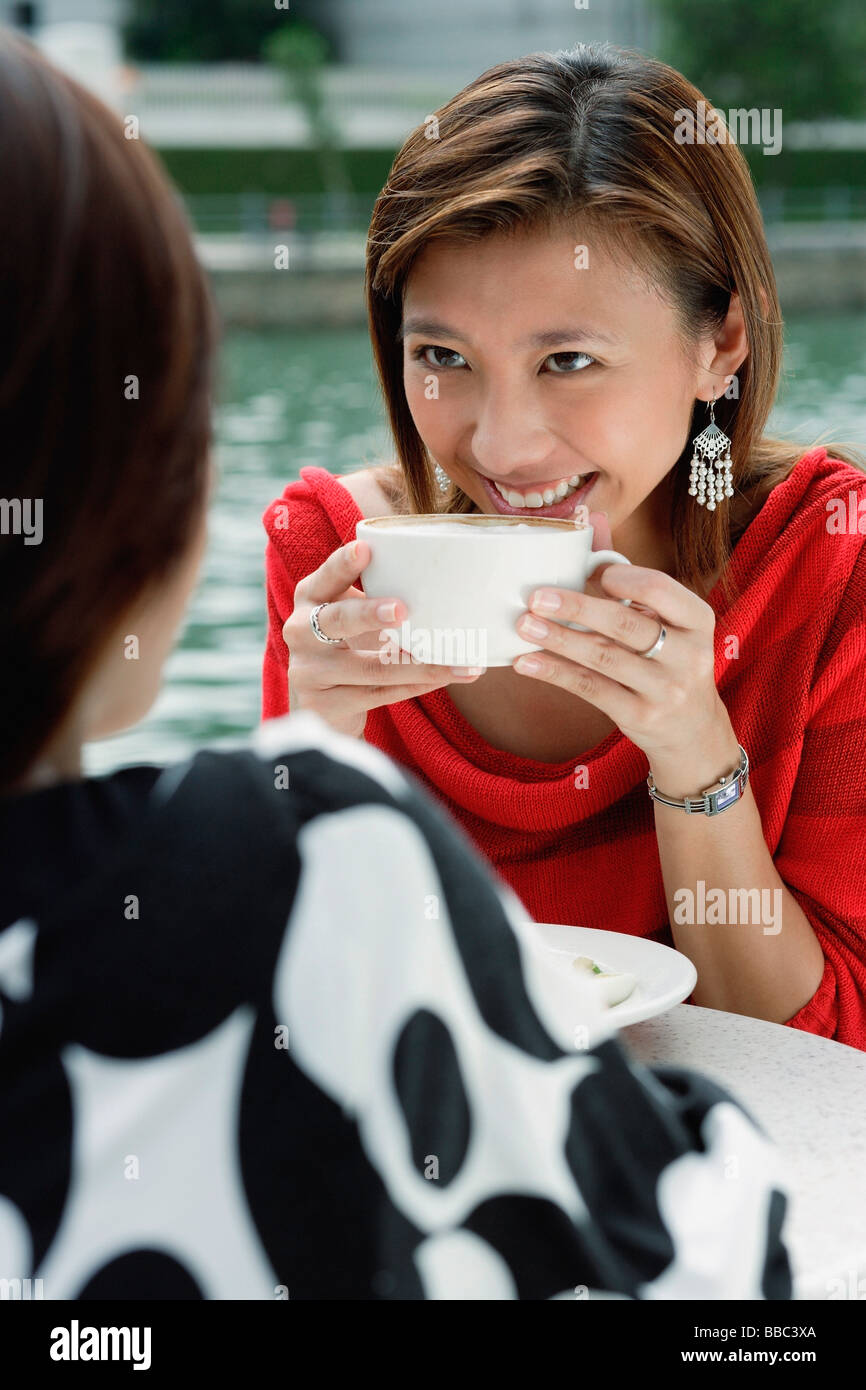 Two women having coffee Stock Photo - Alamy