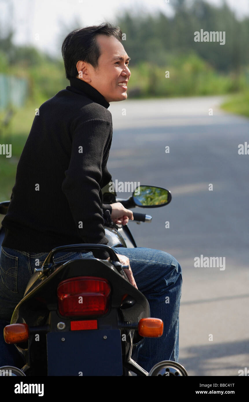 Person sitting on motorcycle hi-res stock photography and images - Alamy