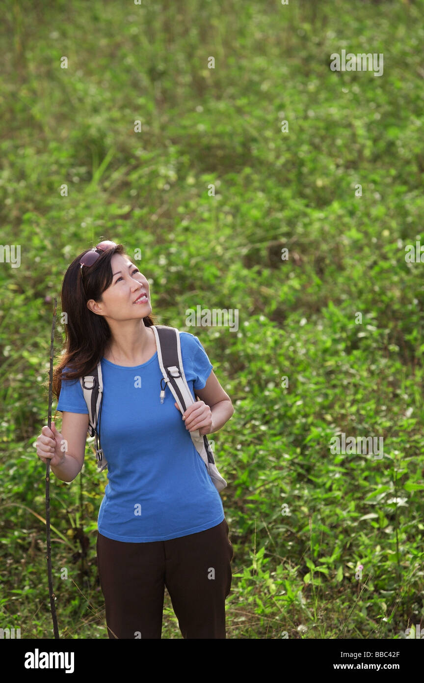 Woman hiking outdoors, nature, looking up to sky Stock Photo - Alamy