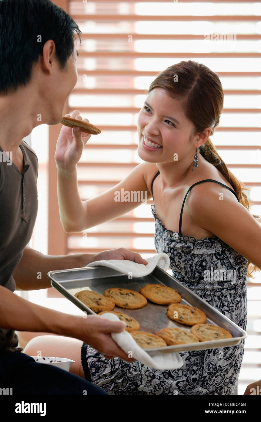 Man feeding cookie woman hi-res stock photography and images - Alamy
