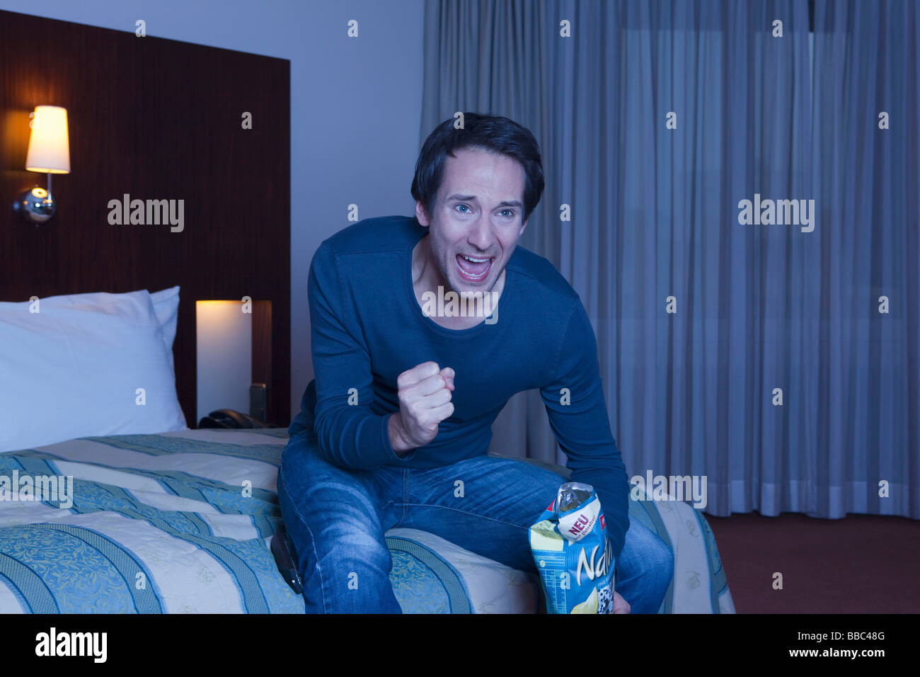 man watching TV, loaded with emotion Stock Photo - Alamy