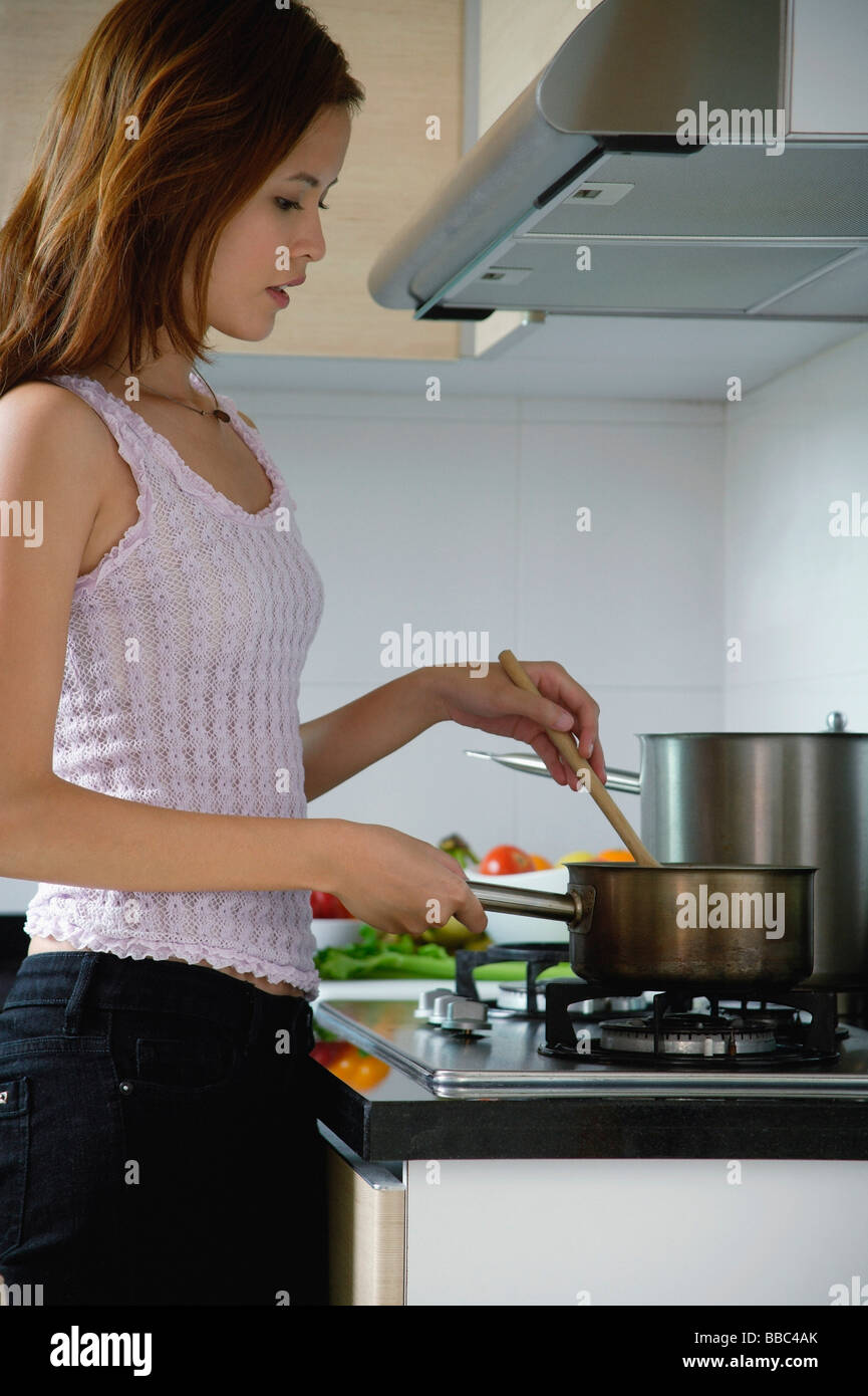 Woman cooking in kitchen Stock Photo - Alamy