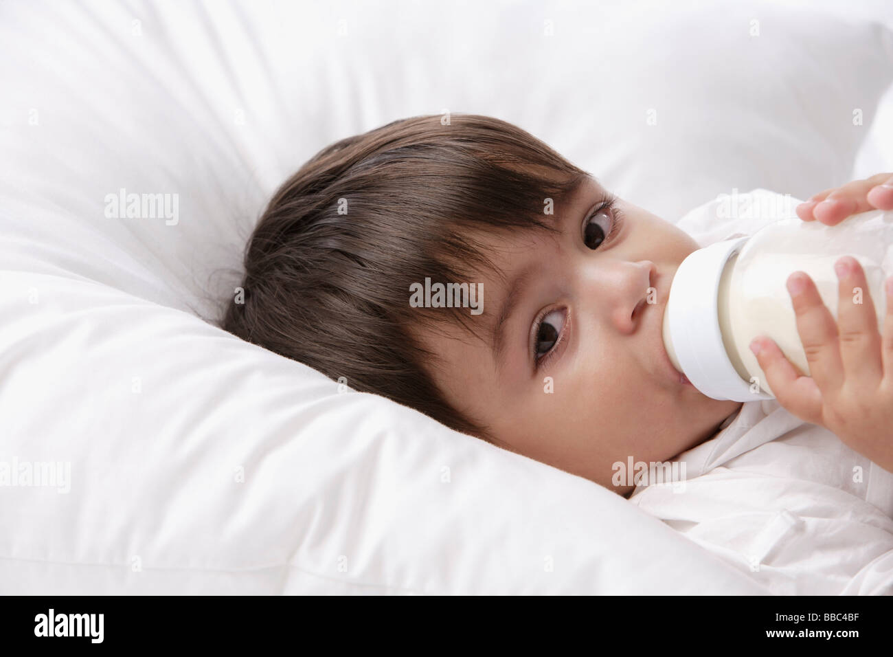 baby boy drinking from bottle Stock Photo - Alamy