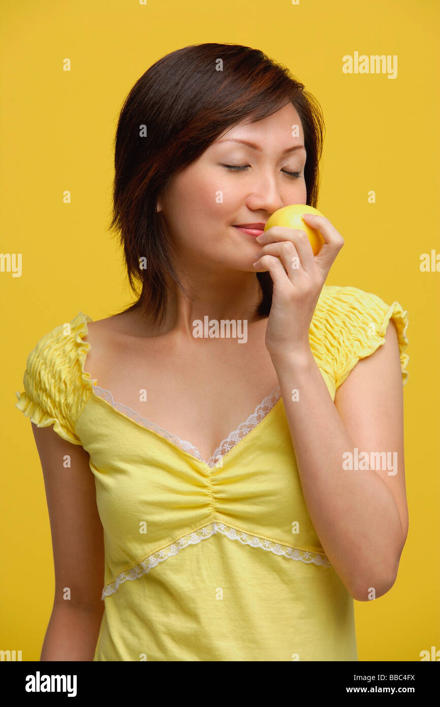 Young woman smelling lemon Stock Photo - Alamy