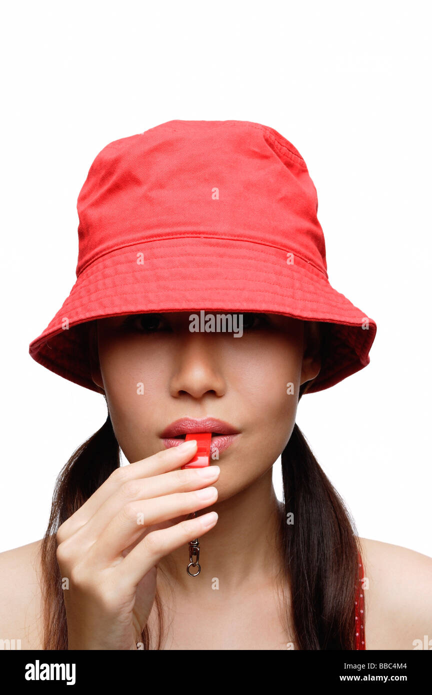 Girl in red blowing whistle, head shot Stock Photo - Alamy