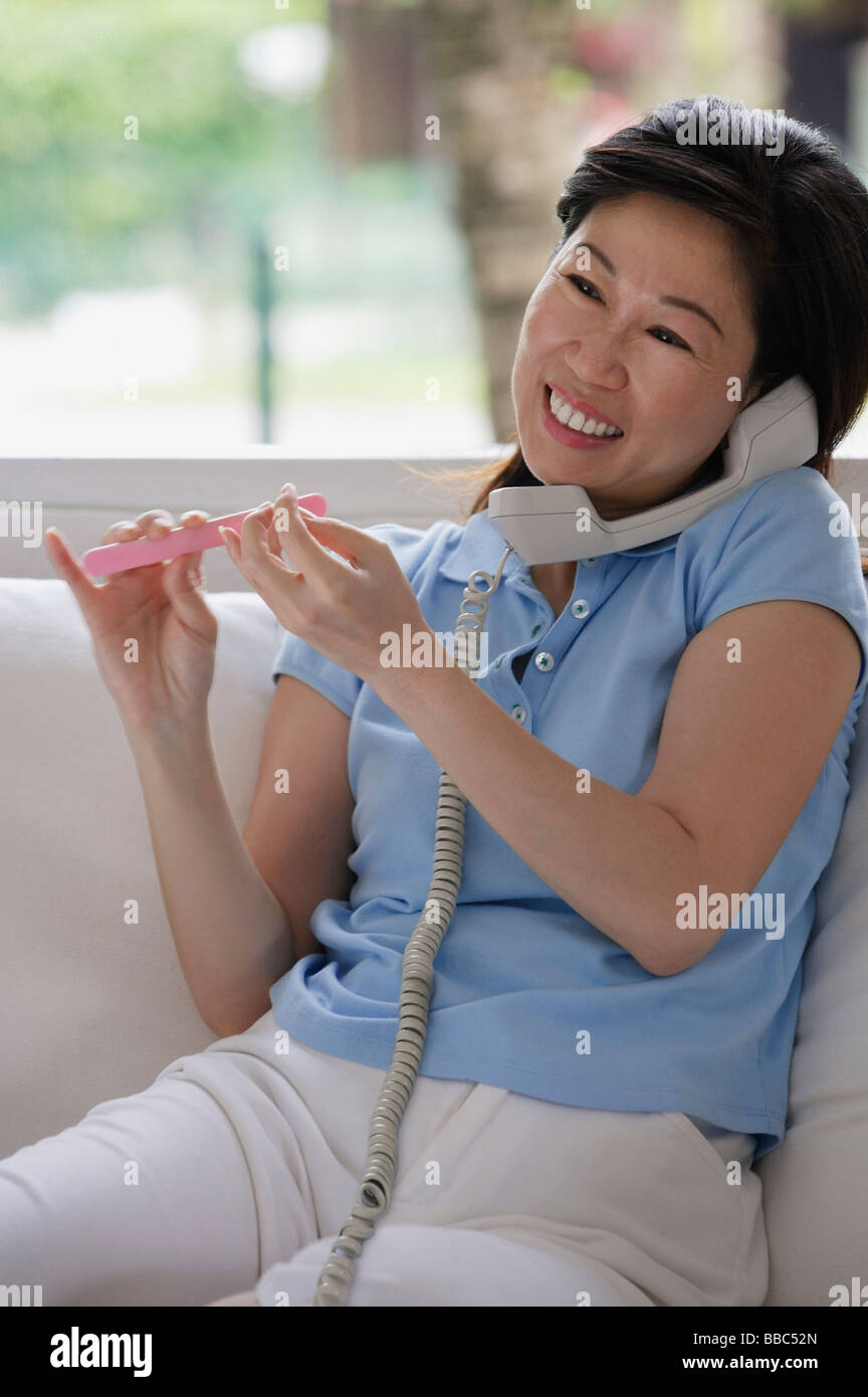 Woman filing nails talking on hi-res stock photography and images - Alamy