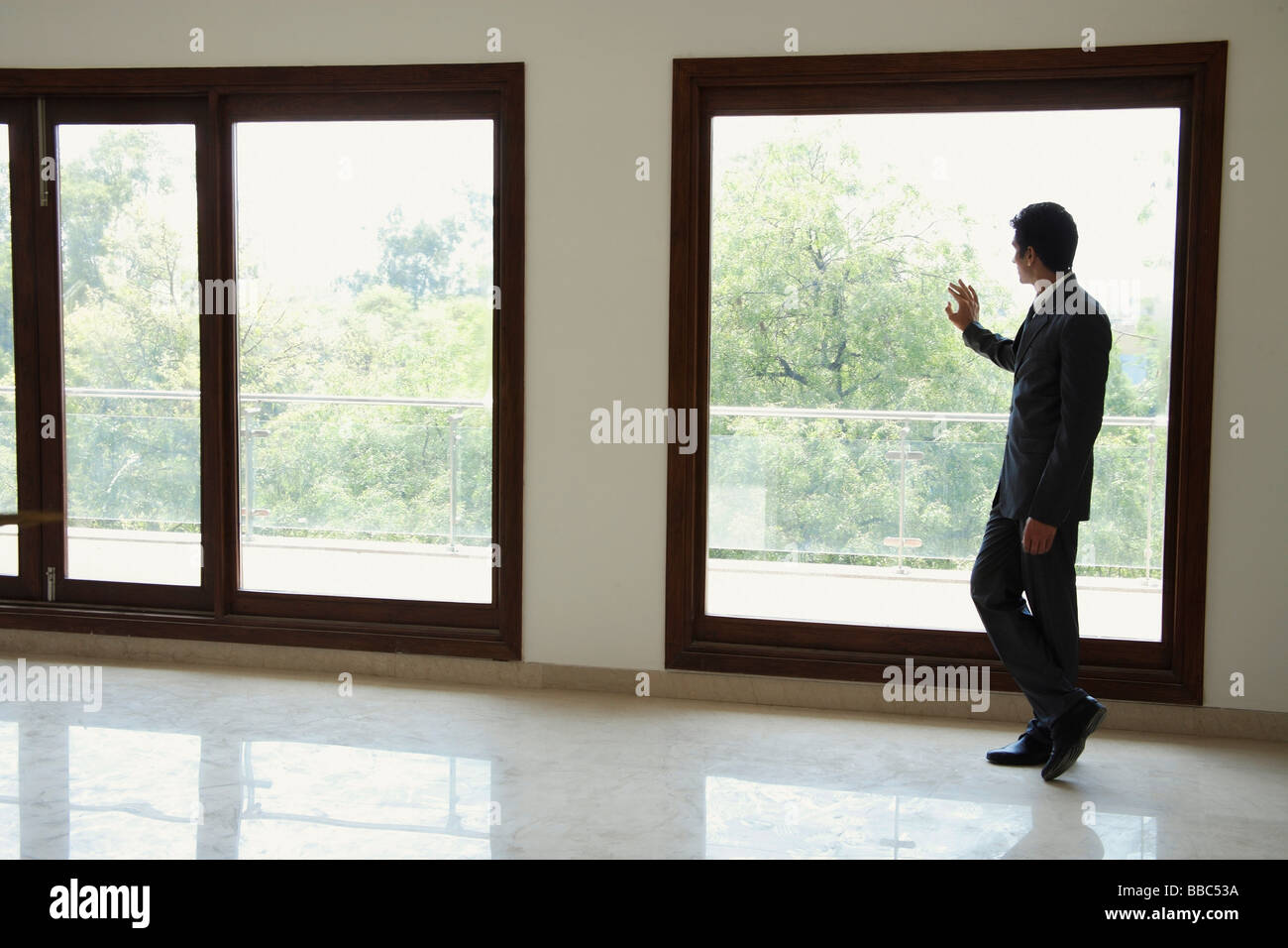 businessman next to window Stock Photo - Alamy