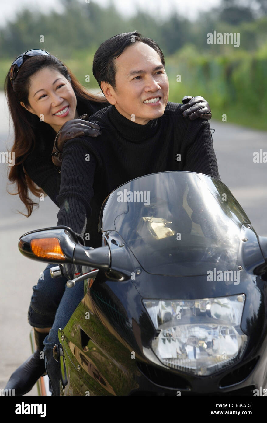 Man and woman on motorcycle Stock Photo - Alamy